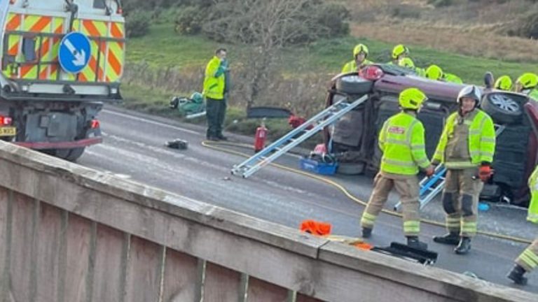 Two in hospital as car crashes into 'sweeper lorry' and lands on side ...