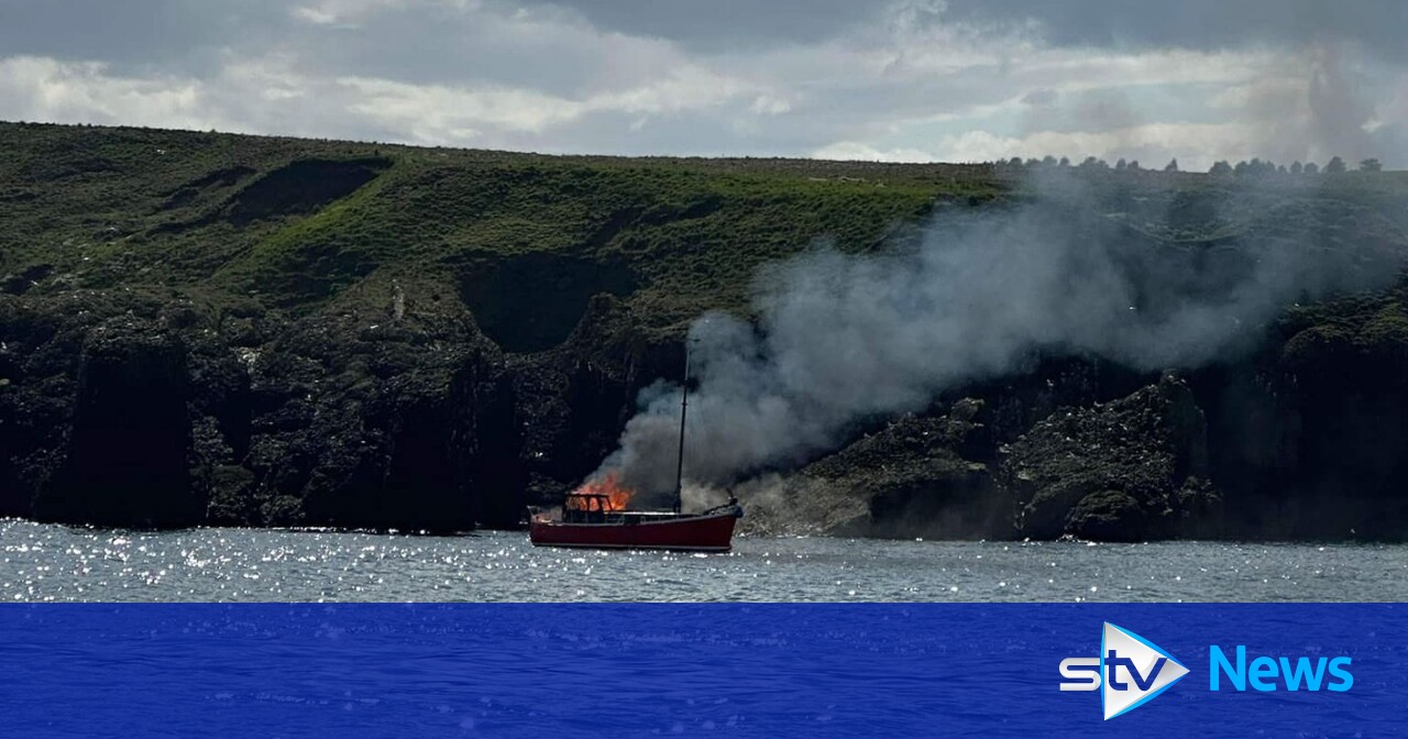 RNLI rescue injured sailor after boat catches fire near historic ...