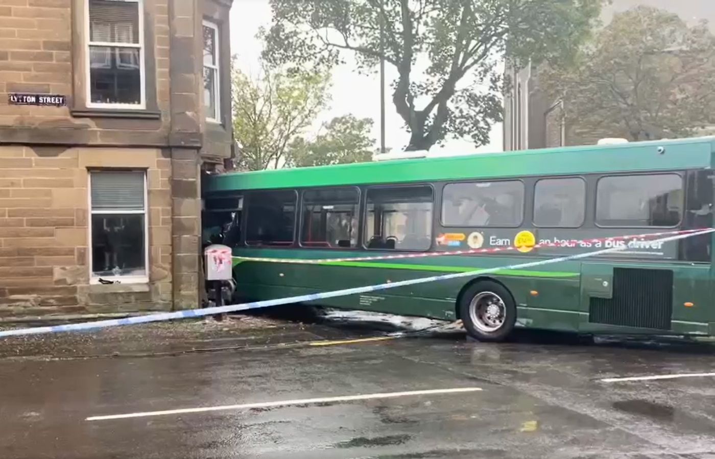 Driver in 'stable condition' after bus crashes into block of flats in ...