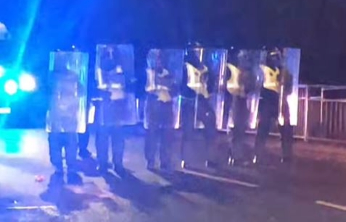 Riot police attacked with fireworks by 'hostile' crowd amid disorder in ...