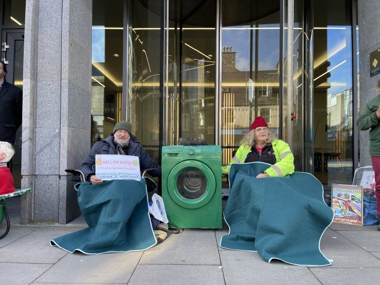 Climate campaigners stage protest at Shell Aberdeen office with washing ...