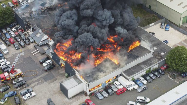 Crews remain overnight after blaze engulfs car repair workshop at ...