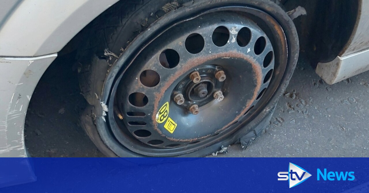 Car taken off road after driver stopped with ripped and deflated tyre ...
