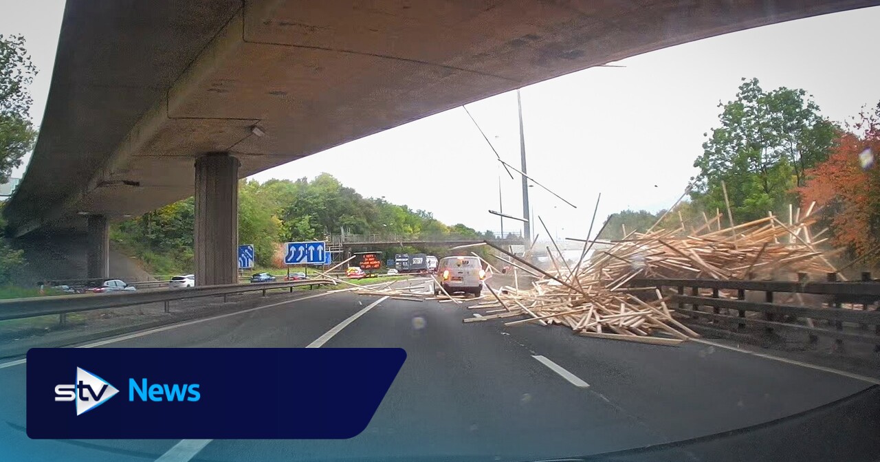 Lorry driver dies after trailer load of timber crashes onto M8 in ...